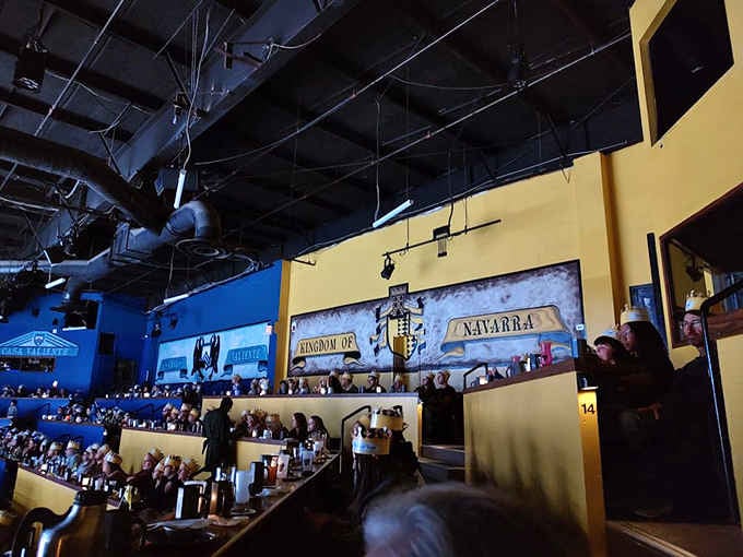 The arena stretches before you, tiered seating facing the tournament ground where dinner meets drama nightly.