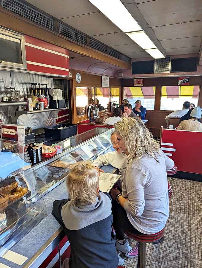 Families sharing meals at the counter, because Mickey's brings generations together over eggs and conversation.