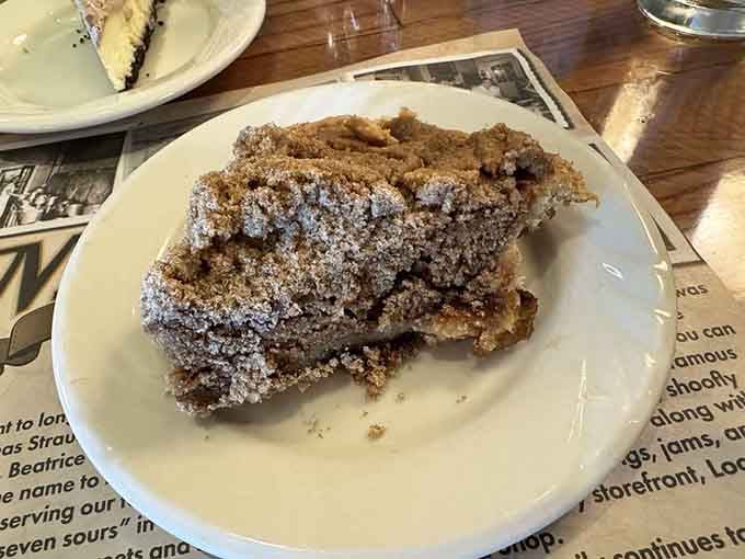 A generous slice of shoofly pie dusted with powdered sugar, sweet enough to attract attention from miles away.