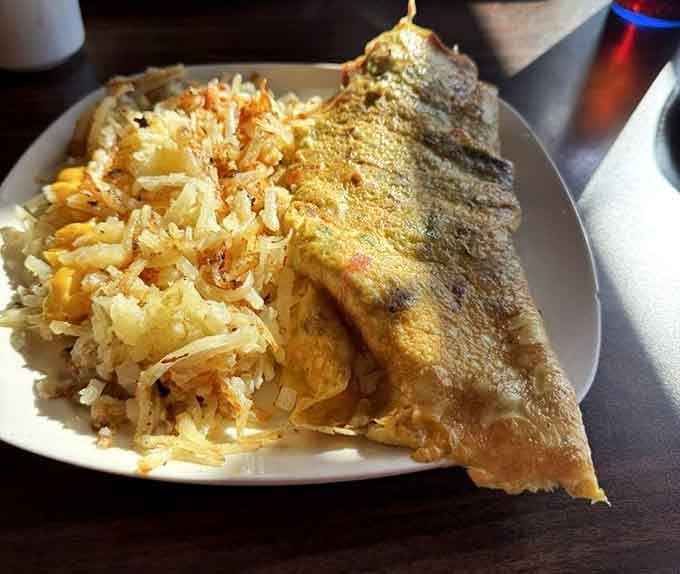 A golden omelet paired with crispy hash browns—simple ingredients transformed into something that feels like a warm hug.