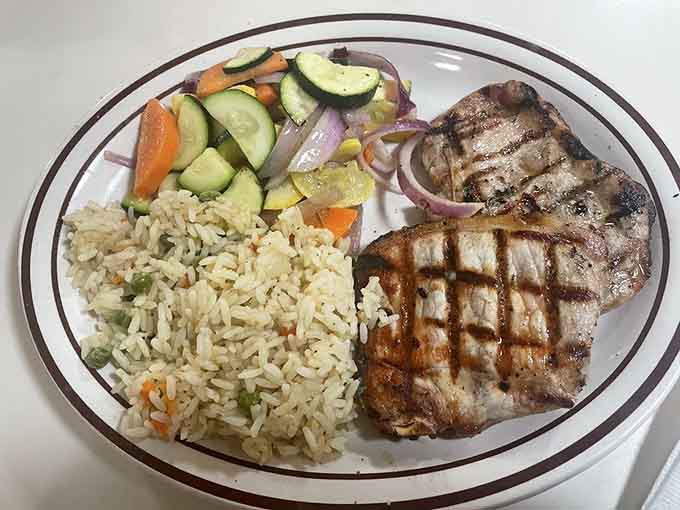 Grilled pork chops with rice and fresh vegetables prove diners can do elegant when they feel like it.