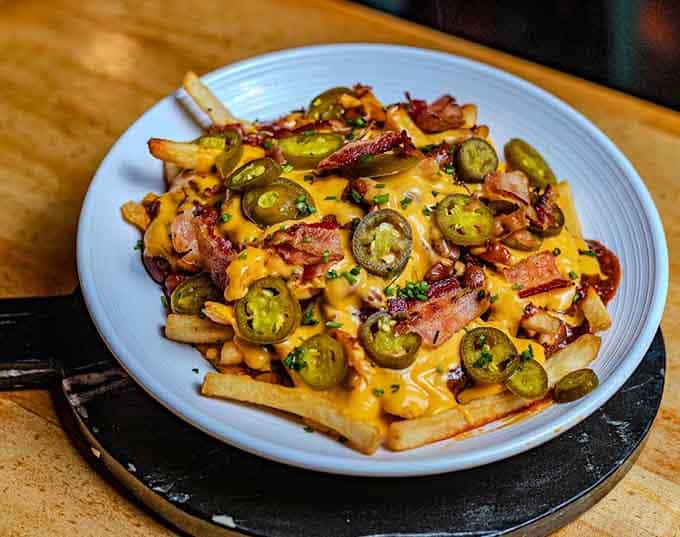 Loaded fries topped with enough bacon and jalapeños to require a strategic eating plan and possibly a nap.