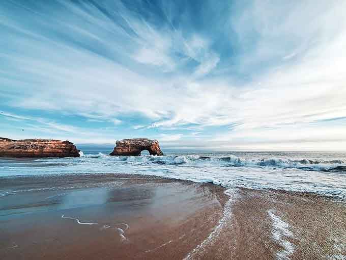 The arch catches that perfect light, creating reflections that would make any photographer weep with joy.