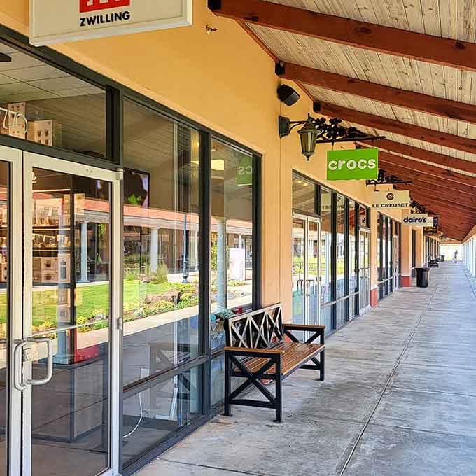 Covered walkways with wooden beams and strategically placed benches&mdash;because marathon shopping requires occasional tactical rest stops.