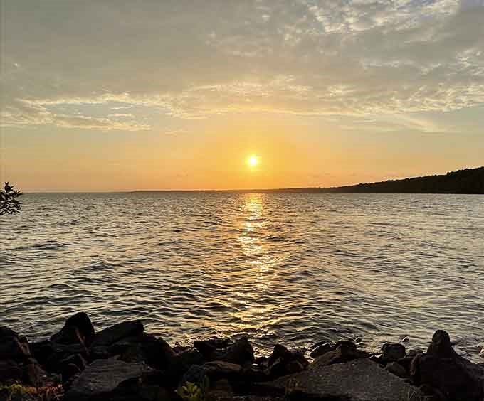 Sunset over Lake Phelps turns the water into liquid gold, proving that the best shows don't require streaming subscriptions.