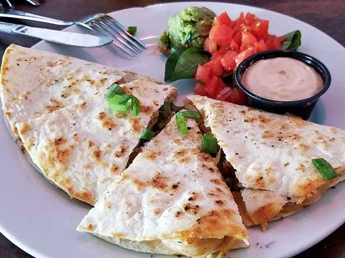 Golden quesadilla triangles served with fresh salsa and sour cream make sharing an actual test of friendship.