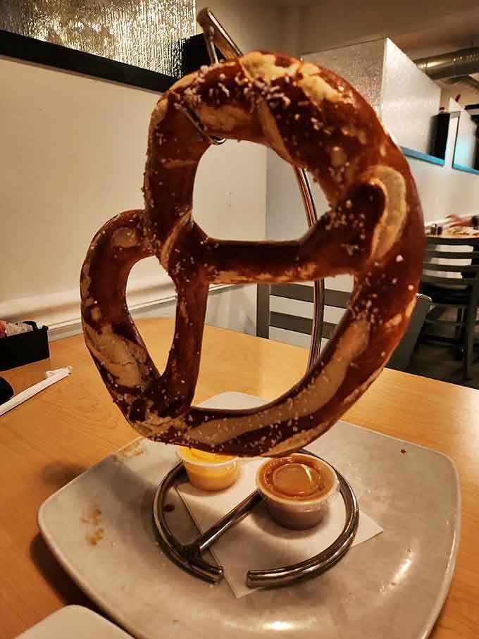 The Giant Bavarian Pretzel arrives suspended like edible architecture, ready for its beer cheese bath. Carb lovers, your moment has arrived.