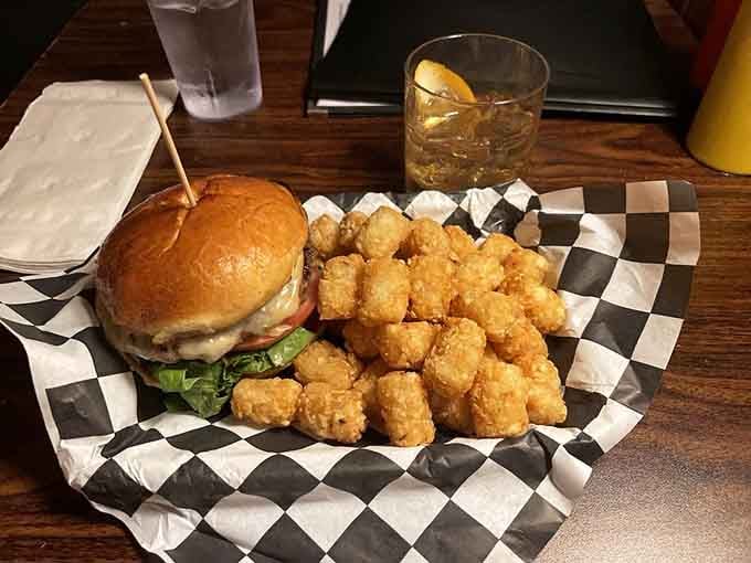 This burger comes with tater tots, proving that some childhood favorites deserve a permanent spot in adulthood.
