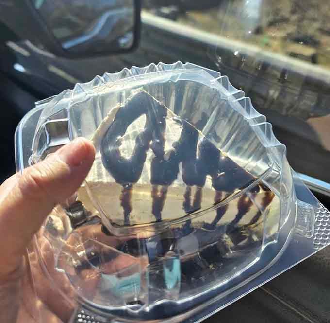 Cheesecake with chocolate drizzle provides the sweet finale your taste buds didn't know they desperately needed after all that smoke.