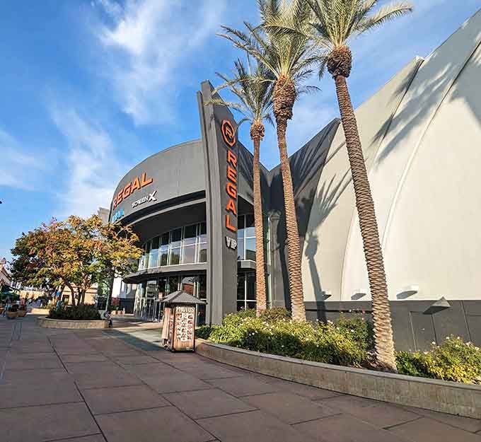 Palm trees stand guard outside Regal Riverpark, where Fresnans escape triple-digit heat for the air-conditioned comfort of Hollywood's latest offerings.