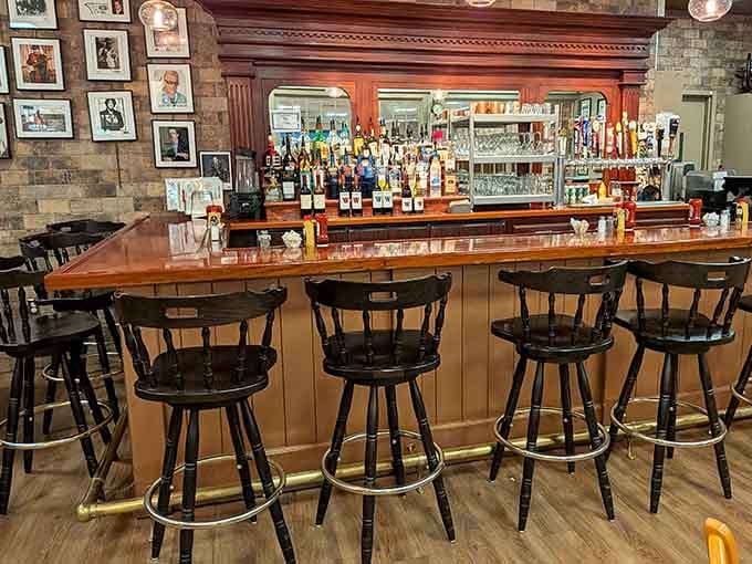 A classic bar setup with vintage photographs watching over the spirits, adding character to every corner.