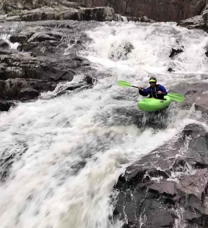 Brave kayakers navigate the cascading rapids, proving adventure seekers find thrills in unexpected Missouri locations.