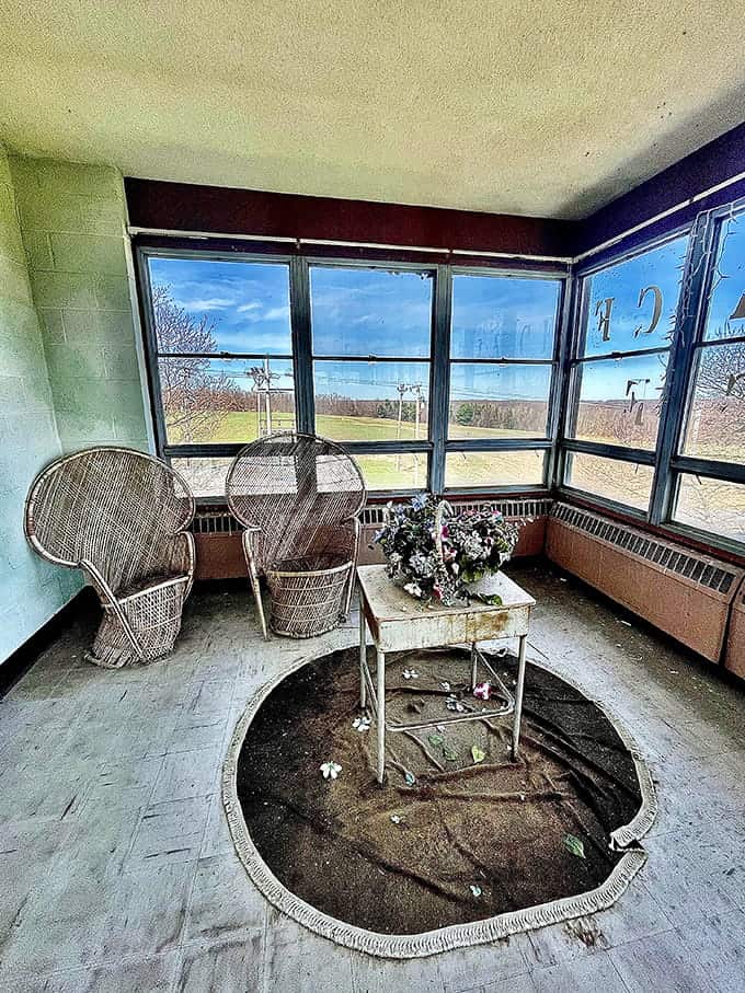 This sunroom with its wicker furniture and large windows once offered residents a peaceful retreat overlooking the countryside beyond.