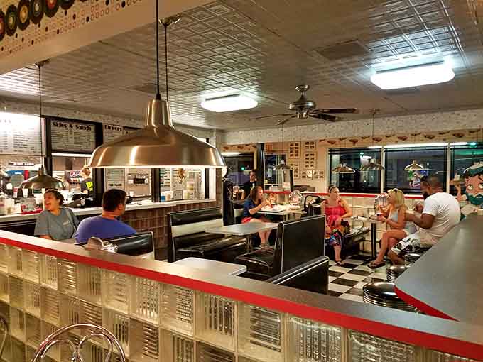 Diners enjoying their meals in booths where countless road trip stories have been shared over the decades.