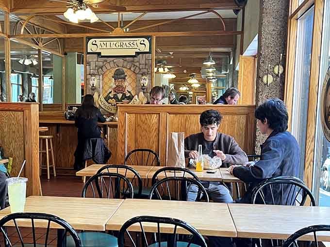 Diners hunched over their sandwiches in concentrated bliss, the universal posture of serious sandwich consumption in progress.