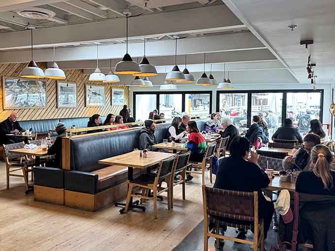 The dining room buzzes with happy conversations as guests enjoy their meals surrounded by warm wood tones and those spectacular views.