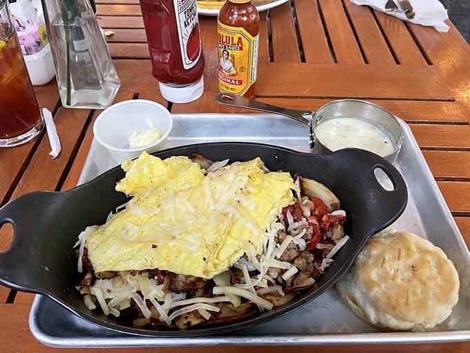 That skillet arrives at your table like a cast-iron promise of satisfaction, loaded with everything breakfast should be.