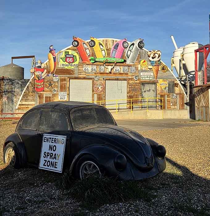 This pristine black Bug serves as the "no spray zone" reminder, the only vehicle spared from the colorful madness.