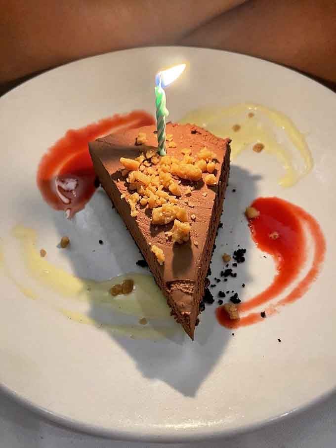 Chocolate mousse pie with a birthday candle, because every visit to St. Elmo feels like celebrating something special anyway.