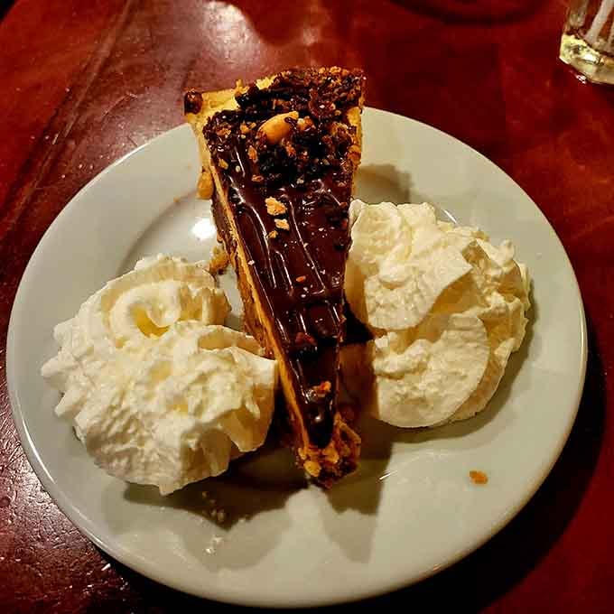 Snickers pie topped with chocolate and flanked by whipped cream mountains, because calories don't count when you're celebrating life with dessert.