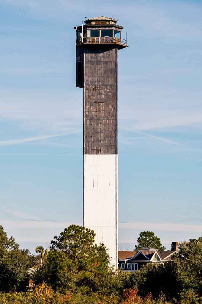 The tower's weathered surface catches afternoon light, revealing textures and tones that only decades of coastal living can create with such character.