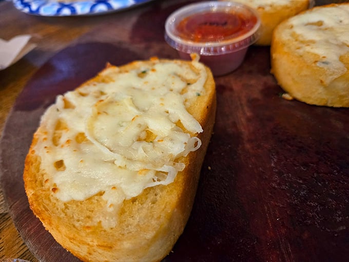 Garlic bread glistening with butter and cheese, because sometimes the sides deserve as much attention.
