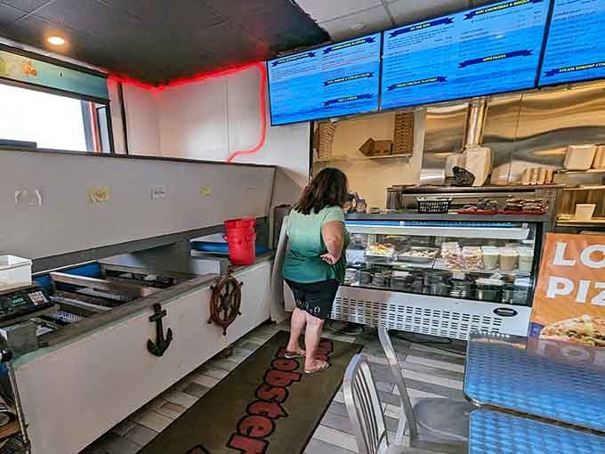 The ordering counter where magic happens, complete with digital menus displaying all the seafood treasures awaiting your selection.