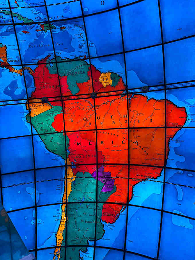 South America glows in vibrant reds and oranges, each country clearly defined in this 1935 snapshot of our world.