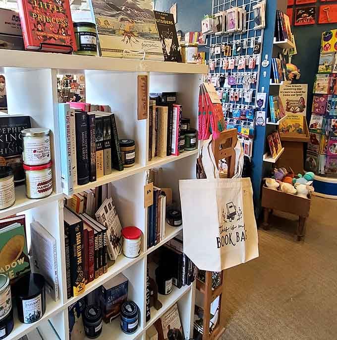 Candles, tote bags, and bookish gifts line the shelves because readers need accessories for their literary lifestyle.