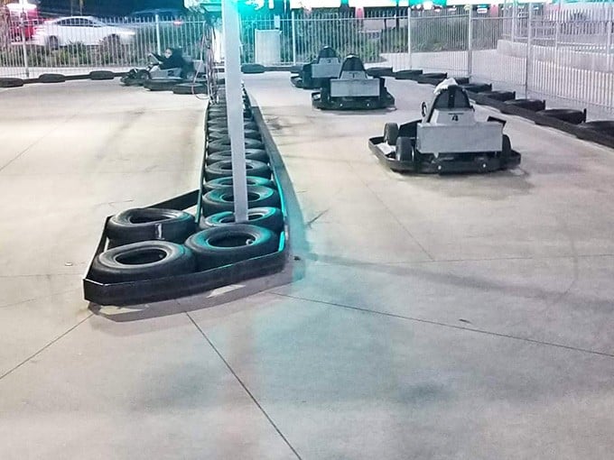 Tire barriers standing guard like rubber sentinels, ready to forgive your questionable cornering decisions with a gentle bounce.