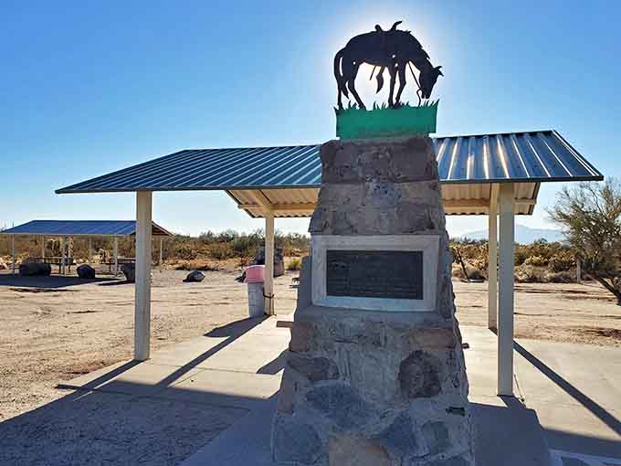 The Tom Mix Memorial stands as a poignant tribute to Hollywood's cowboy star, silhouetted against the vast Sonoran sky that he loved.