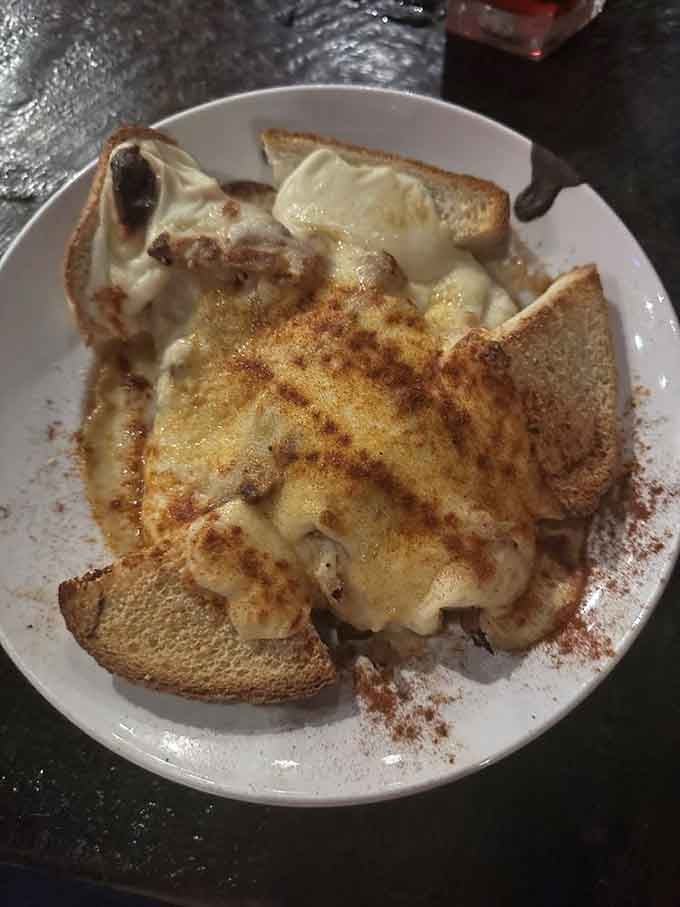 The Kentucky Hot Brown gets the troll treatment, all creamy, cheesy, open-faced glory on toasted bread.