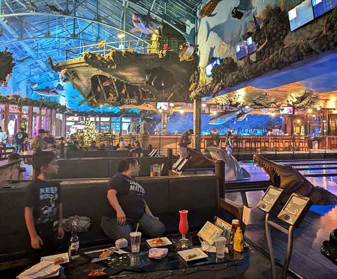 Families gather beneath suspended fish and weathered wood, creating memories in this wonderfully bizarre underwater lodge setting.