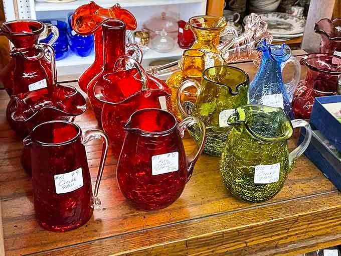 Colored glass pitchers catching the light like liquid jewels, their vibrant hues brightening any windowsill or table.
