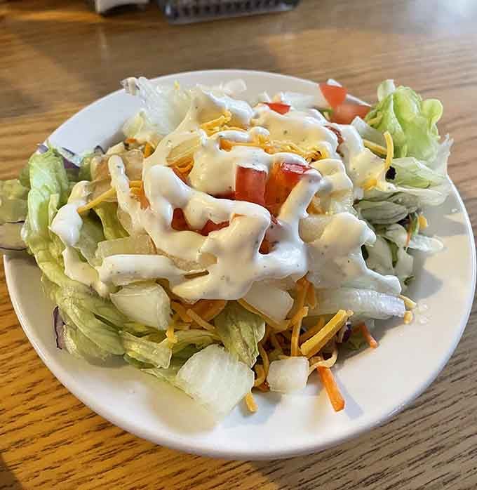 Even the salads here understand their supporting role—fresh, crisp, and ready to balance all that glorious richness.