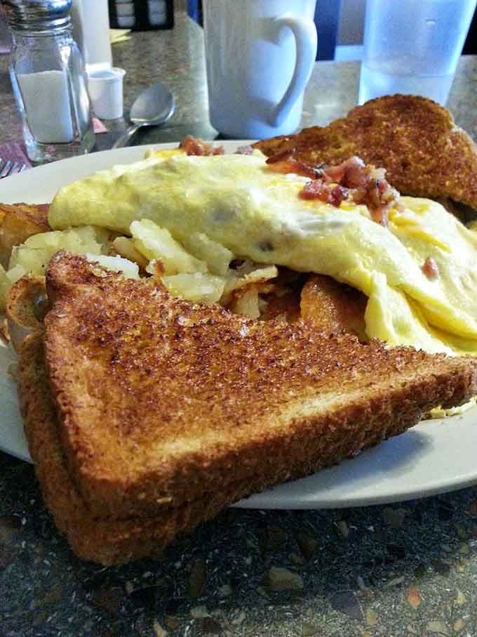 This bacon cheese omelet arrives fluffy and generous, accompanied by perfectly crisped toast for good measure.