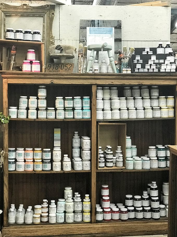 A painter's dream library of possibilities. This meticulously organized collection of chalk paint offers the promise of transformation for furniture treasure hunters.