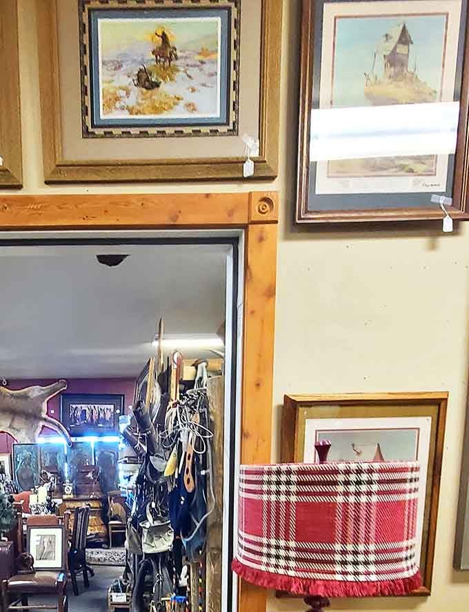 Western artwork frames a doorway to another room, each painting telling stories of cowboys and landscapes that defined the frontier.