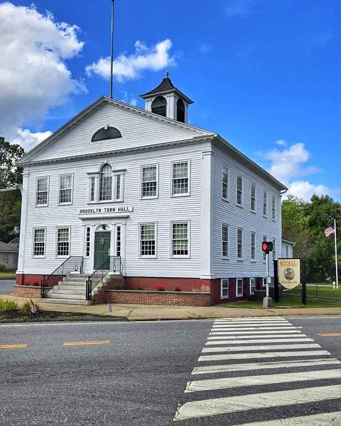 Brooklyn Town Hall stands proud in crisp white, its bell tower and arched windows commanding respect from every passing generation.