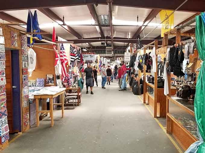 Wide aisles and wooden booths create that classic flea market atmosphere where discovering treasures feels almost effortless and natural.