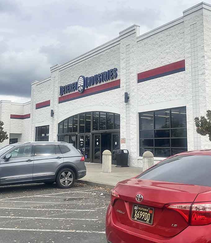 Deseret Industries' crisp white building with red accents stands out like a perfectly preserved vintage find.