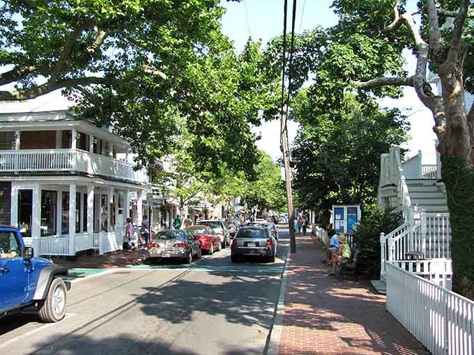 Brick sidewalks and white picket fences line streets where strolling feels less like exercise and more like stepping into a living postcard.
