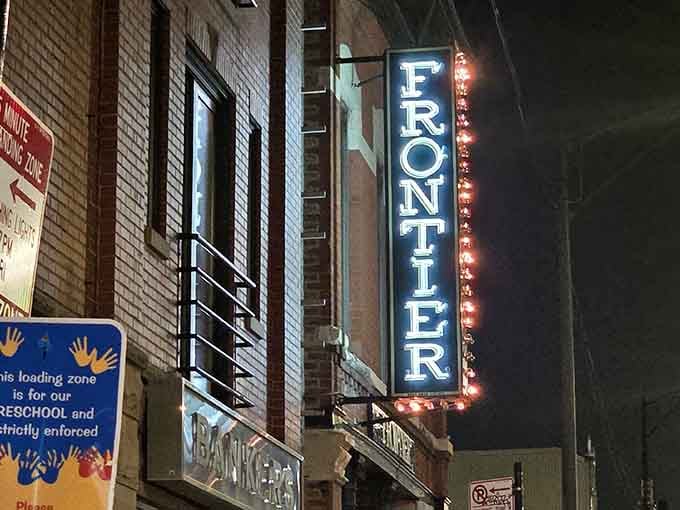 The illuminated Frontier sign cuts through the night like a marquee announcing tonight's delicious Western-inspired performance.