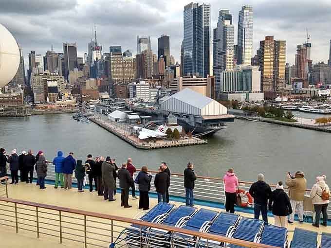 Crowds gather like it's opening night at the theater, except the show is Lady Liberty herself standing proud.