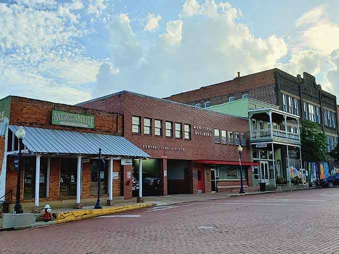 Brick buildings with green awnings create a welcoming streetscape where every storefront invites you to come inside and browse.