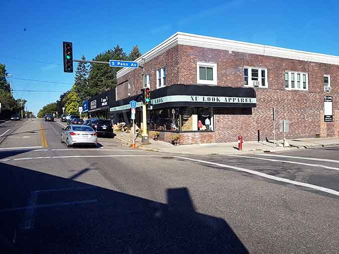 Classic brick architecture and tree-lined streets frame this corner shop where fashion-conscious shoppers discover designer labels at thrift prices.