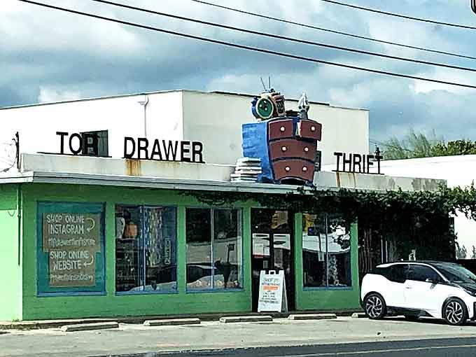 That whimsical rooftop dresser sculpture tells you this isn't your ordinary thrift store &ndash; creativity lives here too.