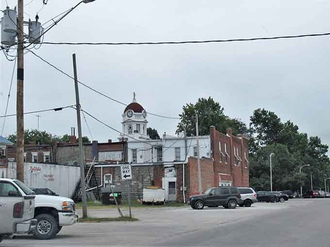 That courthouse dome rises behind weathered buildings like hope persisting through changing times, beautiful in its quiet dignity and strength.