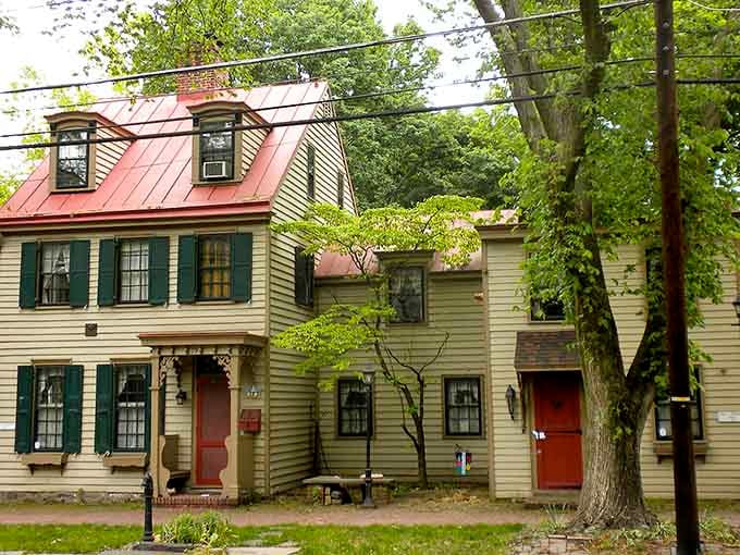 Colonial-era homes wear their red metal roofs like badges of honor, standing shoulder-to-shoulder along streets older than the nation.