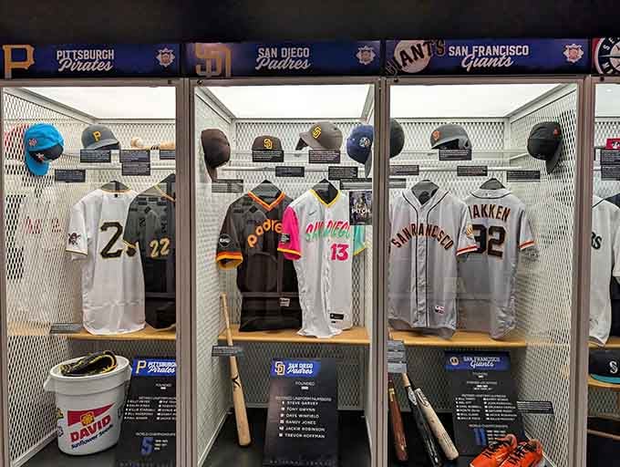 Vintage jerseys and classic caps fill these display cases with decades of baseball history and nostalgia.